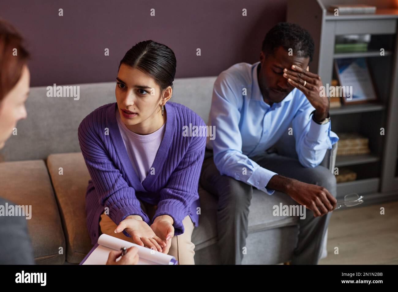 Young woman complaining family psychologist about problems with husband ...