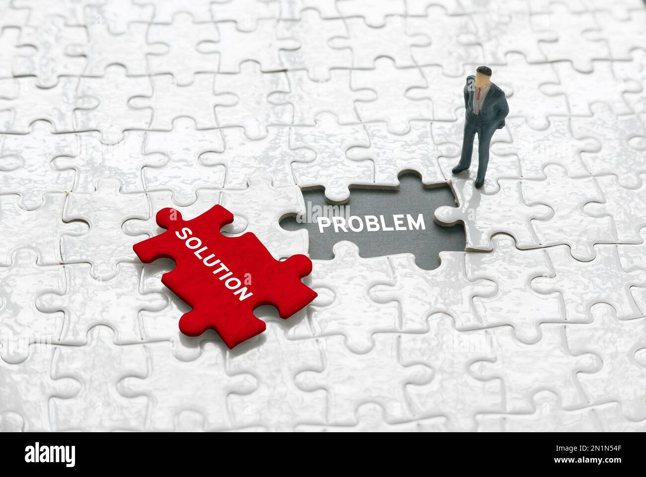 Selective focus of miniature businessman and an empty space of jigsaw ...