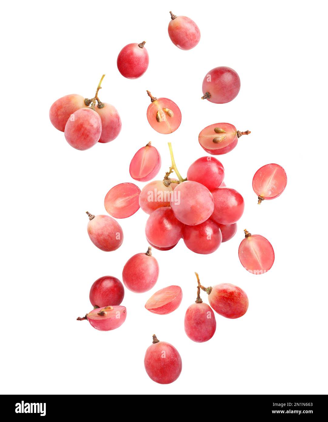 Fresh ripe grapes falling on white background Stock Photo - Alamy