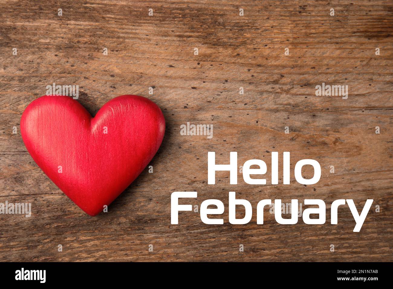 Greeting card with text Hello February. Red decorative heart on wooden ...