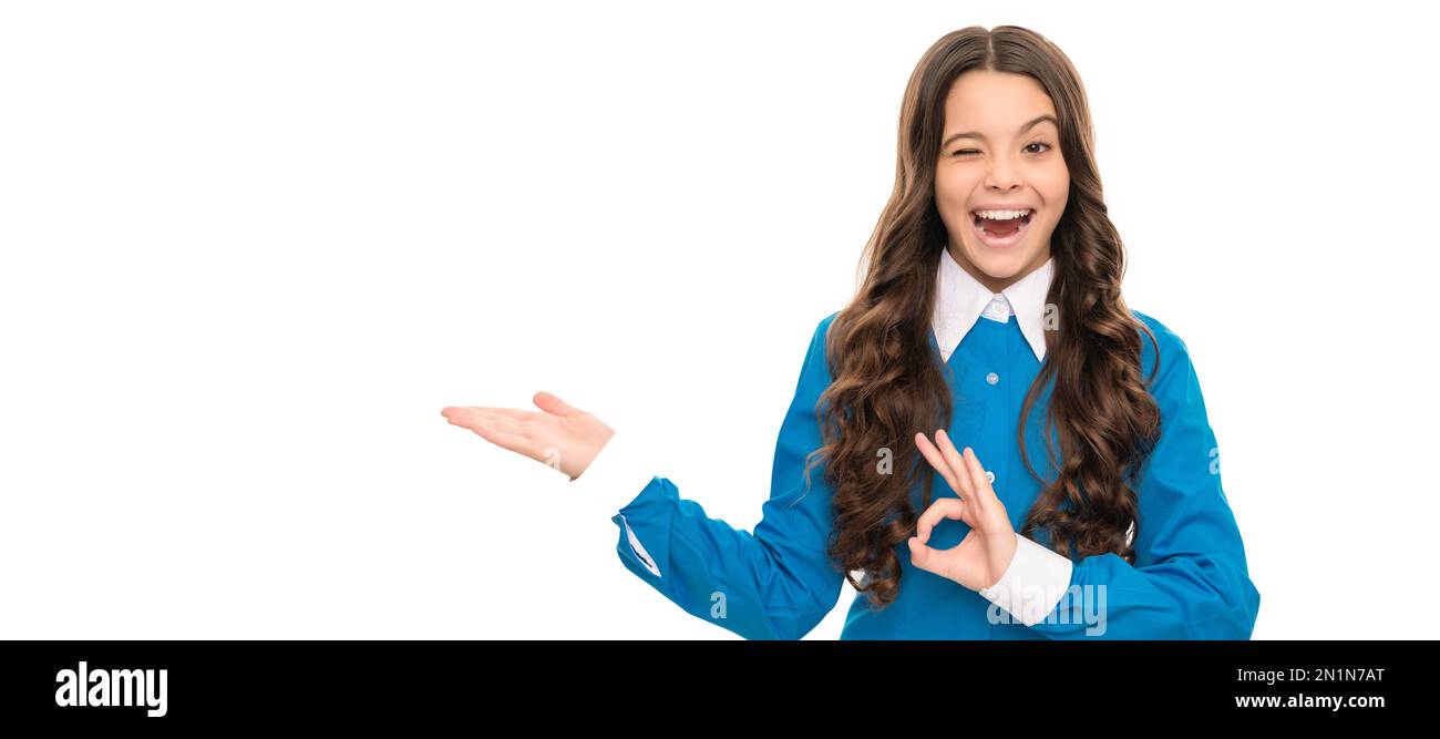 winking face of teen girl presenting product show ok gesture, copy ...