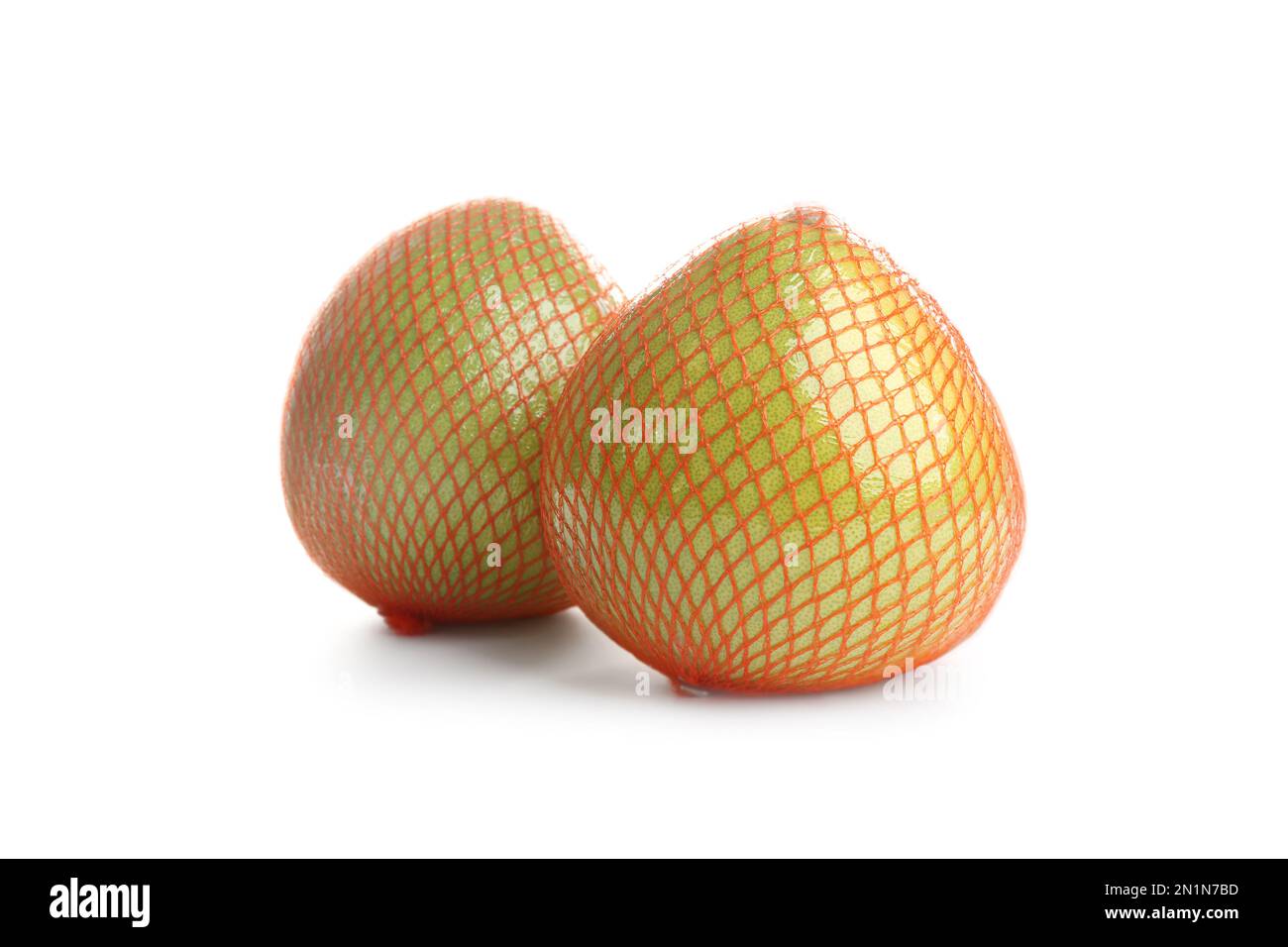 Fresh pomelo fruits in meshes isolated on white Stock Photo - Alamy