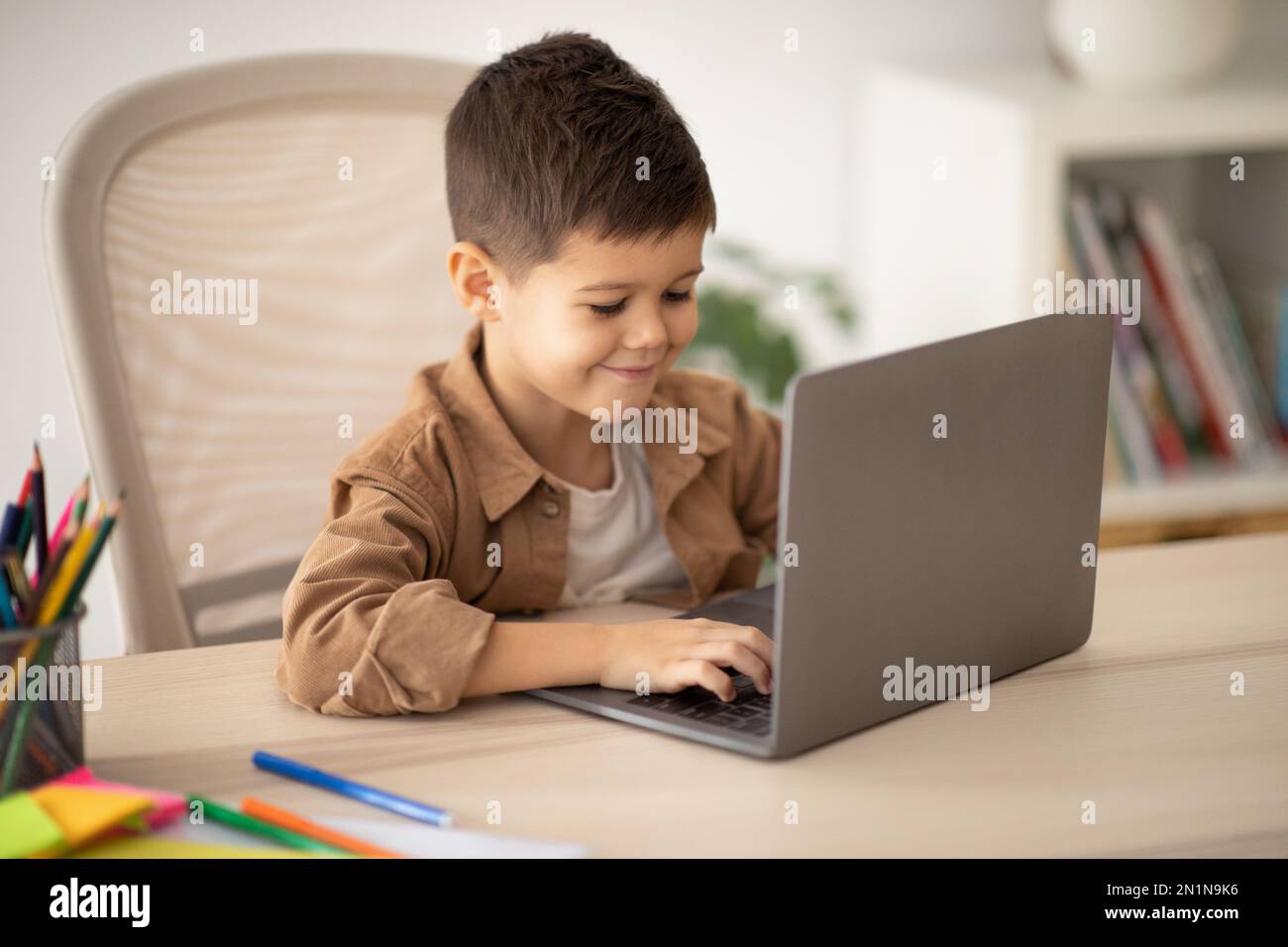 Video call remotely, education game. Glad caucasian little child pupil ...