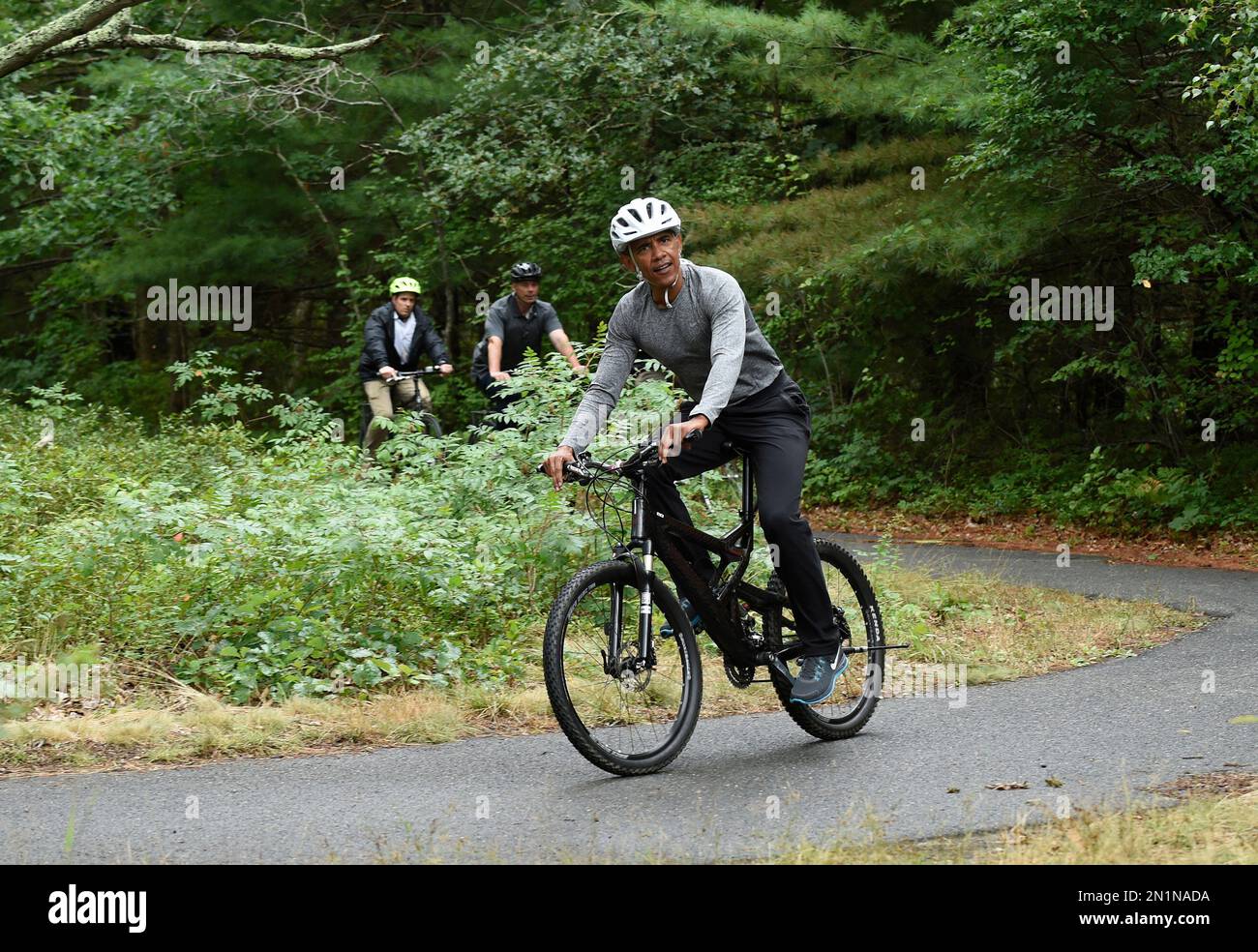 President Barack Obama rides a bike in West Tisbury, Mass., on Martha's ...