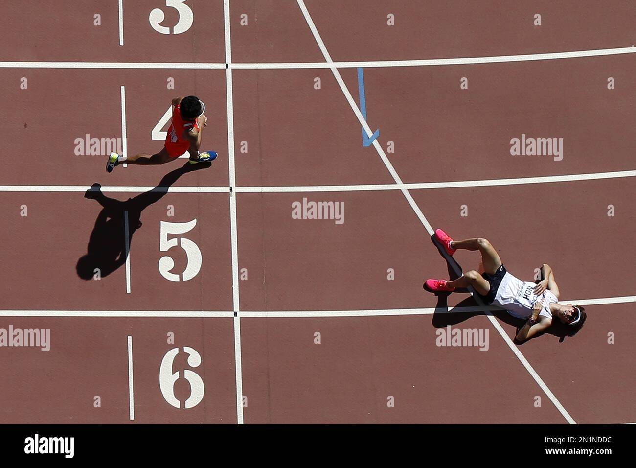 Japan's Kazuhiro Maeda crosses the finish line as South Korea's Noh Si ...