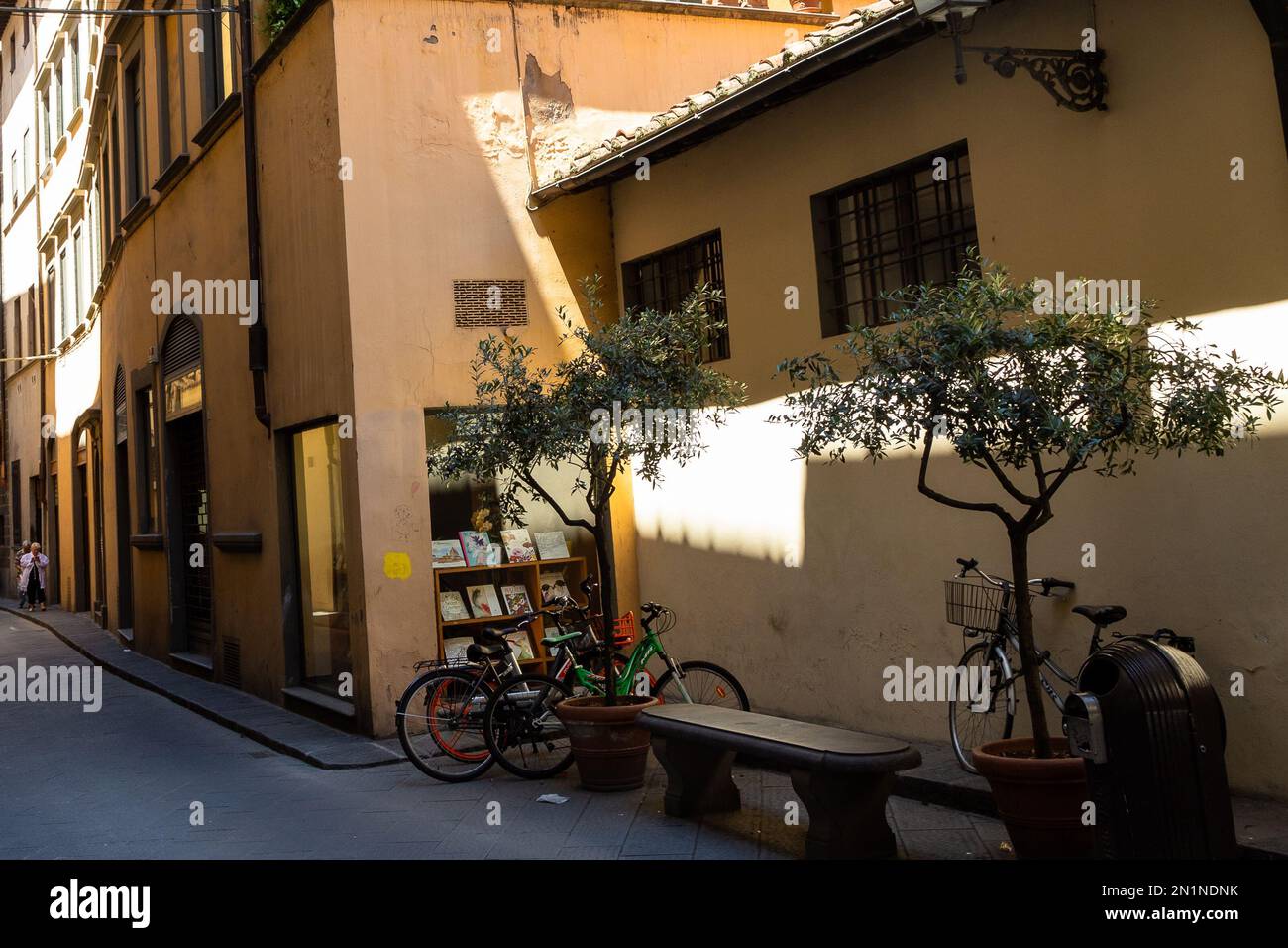 Bicycles leaning against bench on street in Florence Stock Photo - Alamy