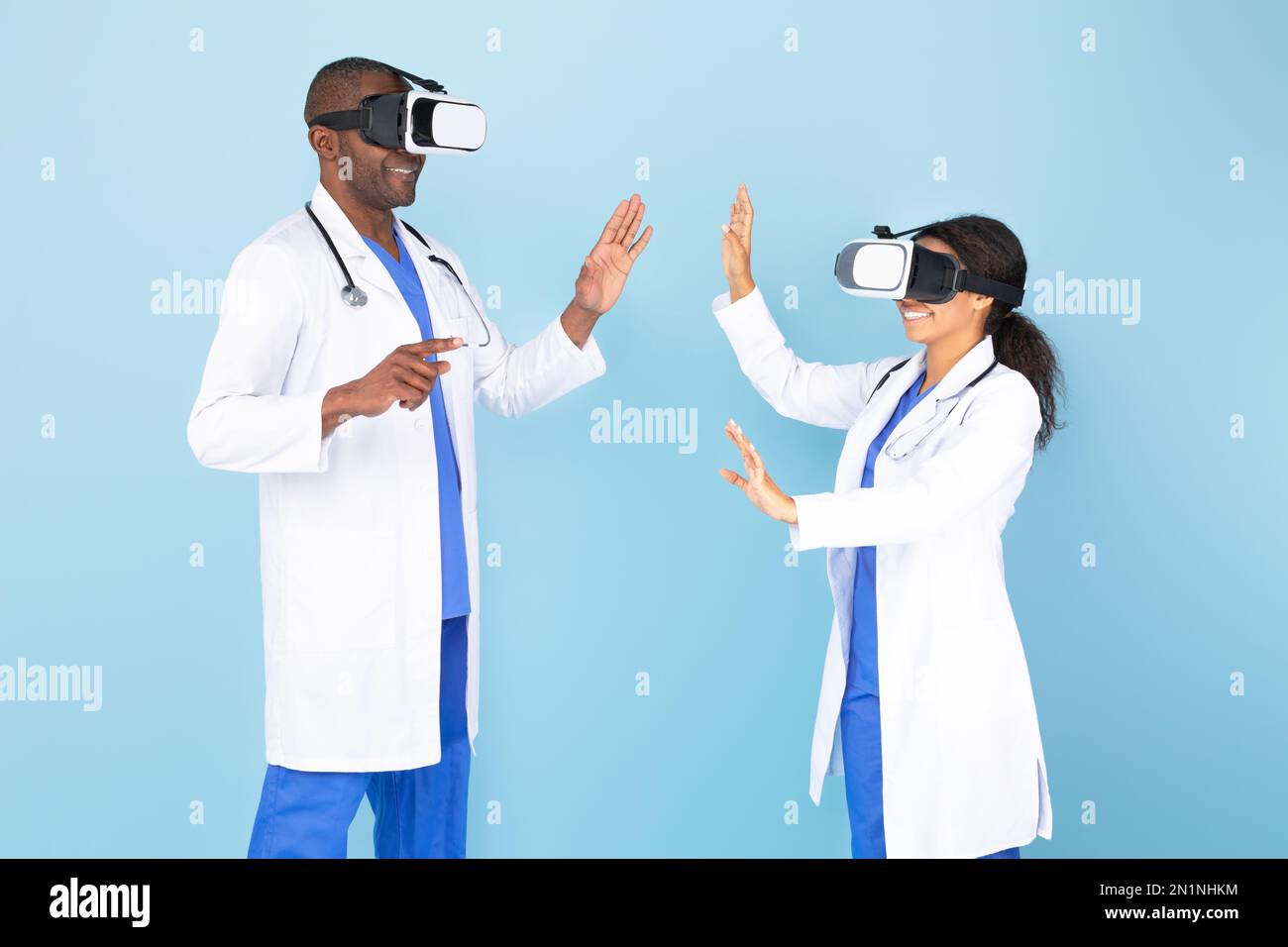 Device for medical education and treatment. Female and male doctors experiencing virtual reality ...