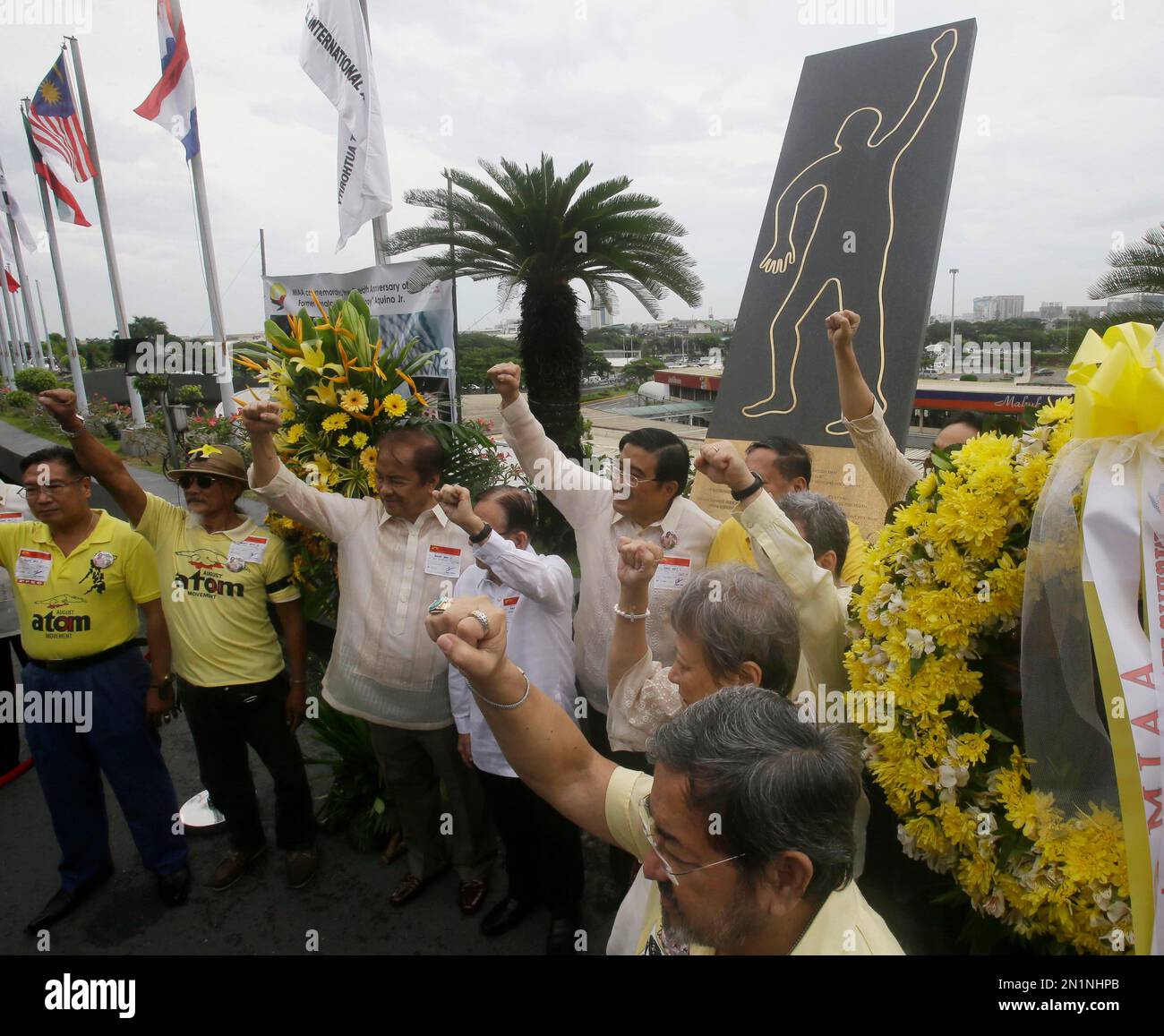Supporters raise their clenched fists during a wreath-laying ceremony ...
