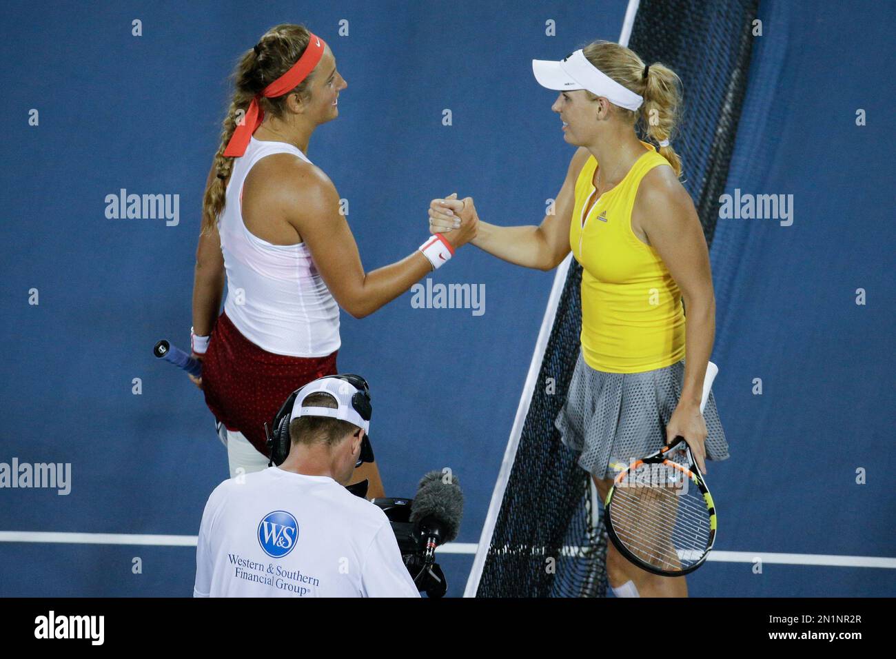 Victoria Azarenka, of Belarus, left, shakes hands with Caroline ...
