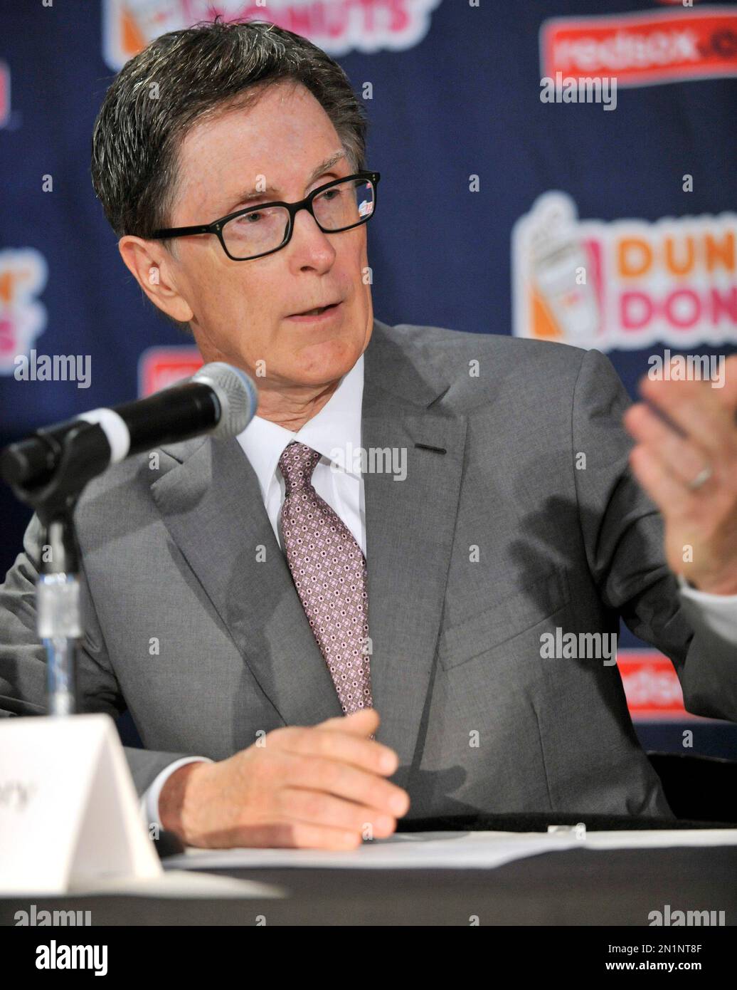 Red Sox Owner John Henry responds to a reporter's question during a ...
