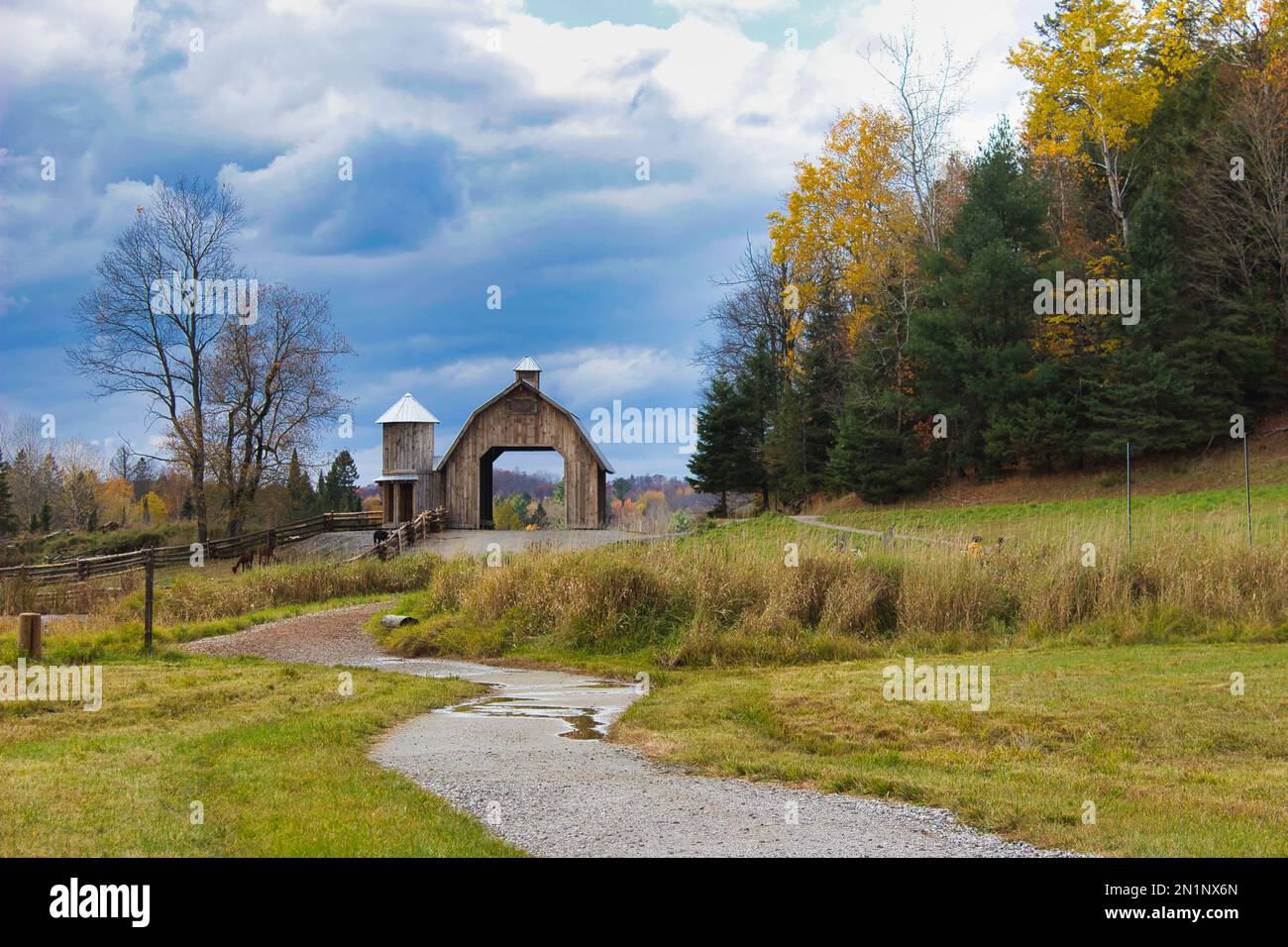 A small wooden arch on the pathway in Parc Omega in Notre-Dame-de ...