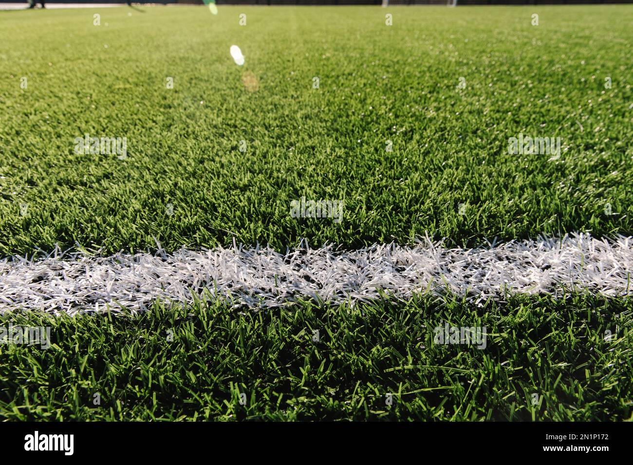 Detailed green soccer field grass lawn texture. White line in centre ...