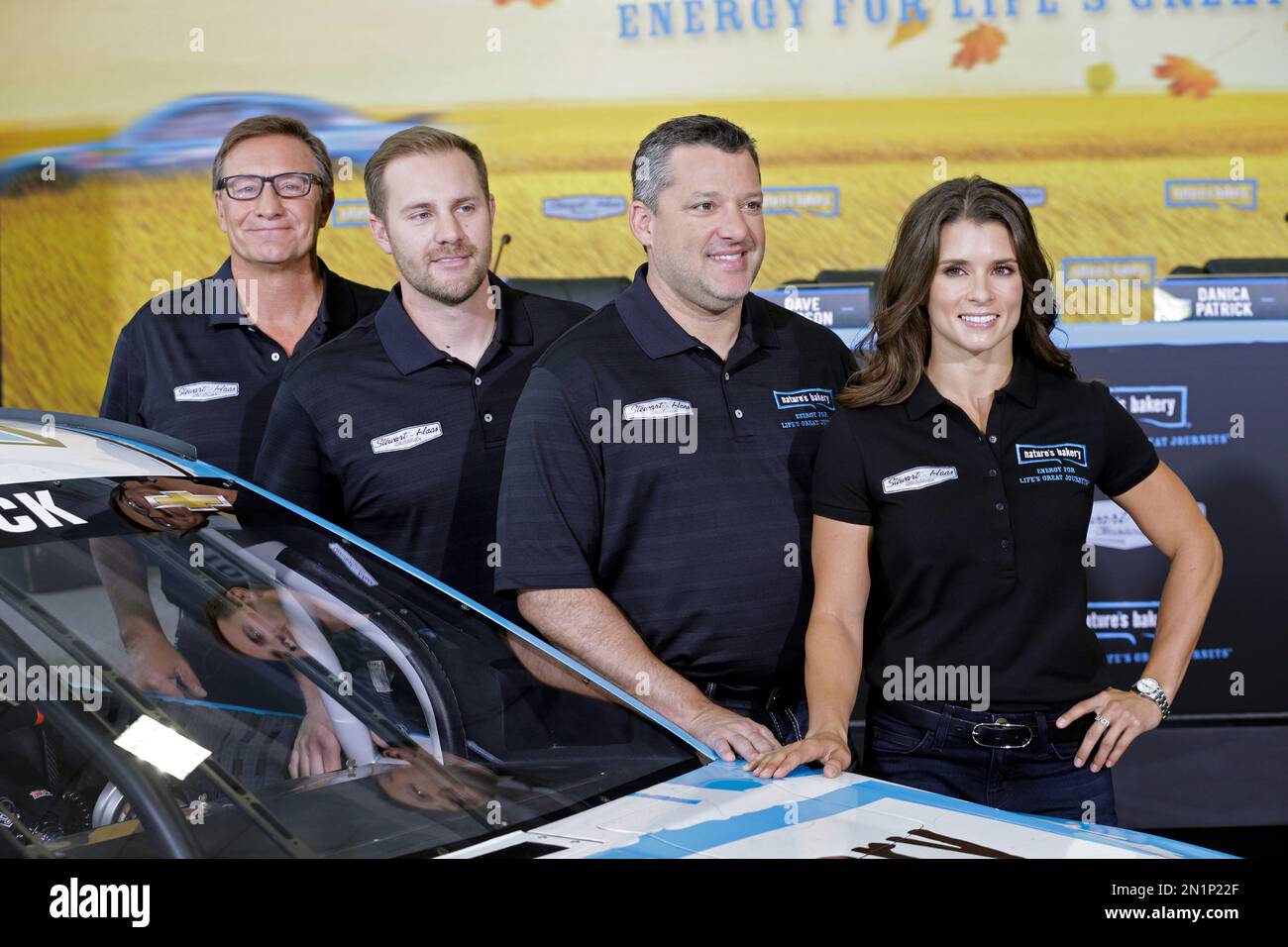 Danica Patrick, right, poses by her new race car with Tony Stewart, Sam ...