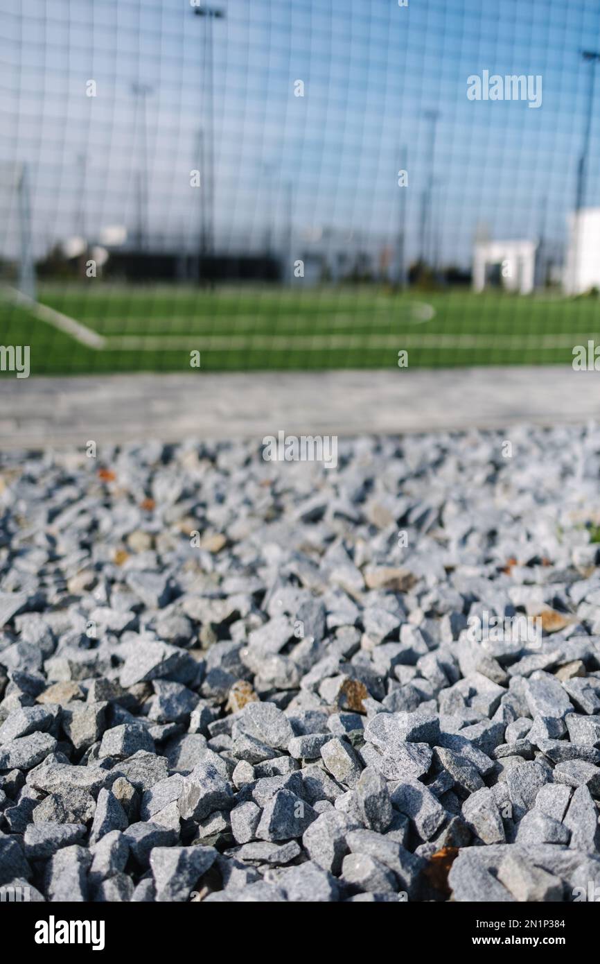 Macro photo of crushed stone. Background of stadium grass football ...