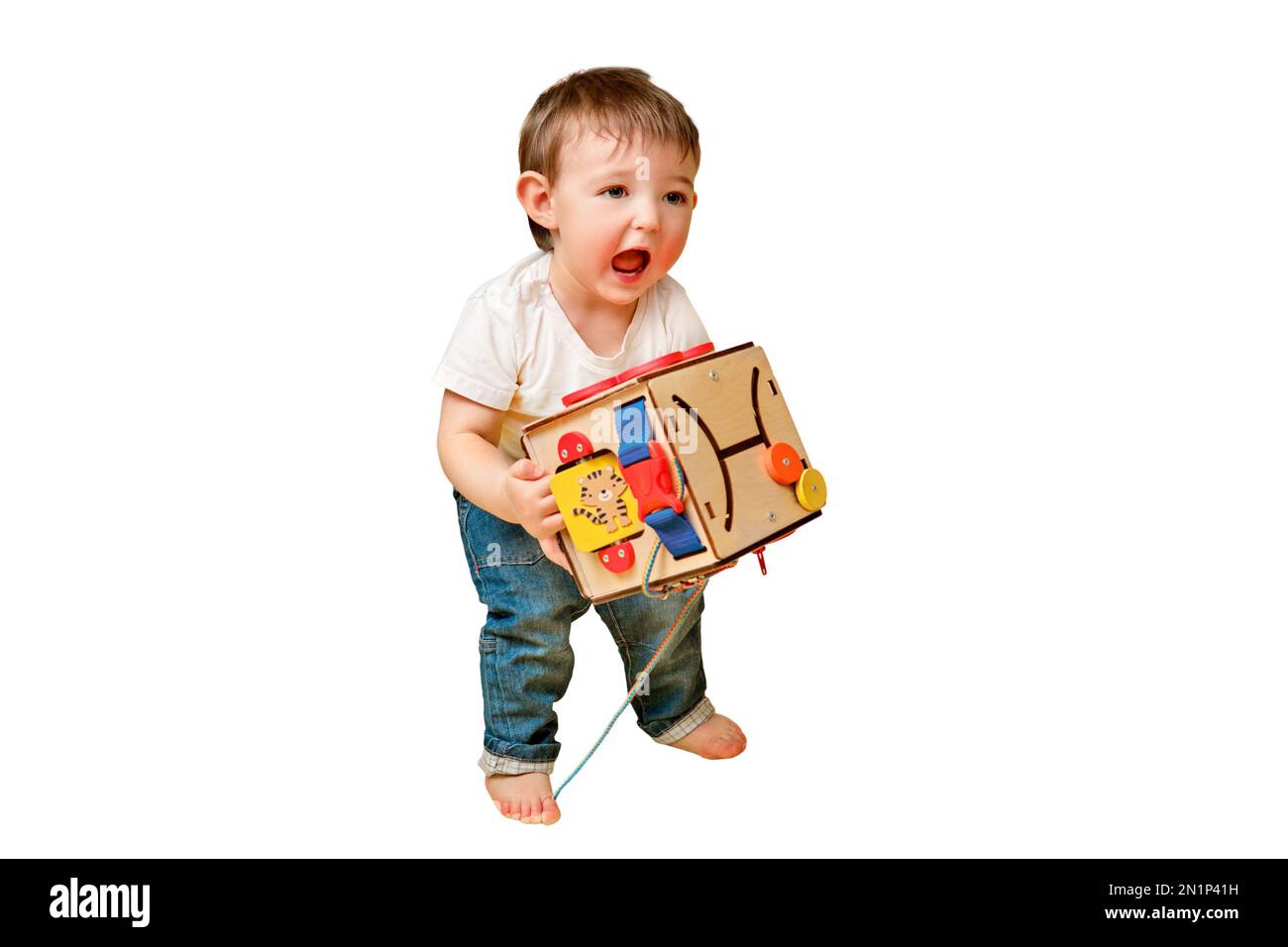 Toddler baby is playing logic educational games busyboard on a studio ...