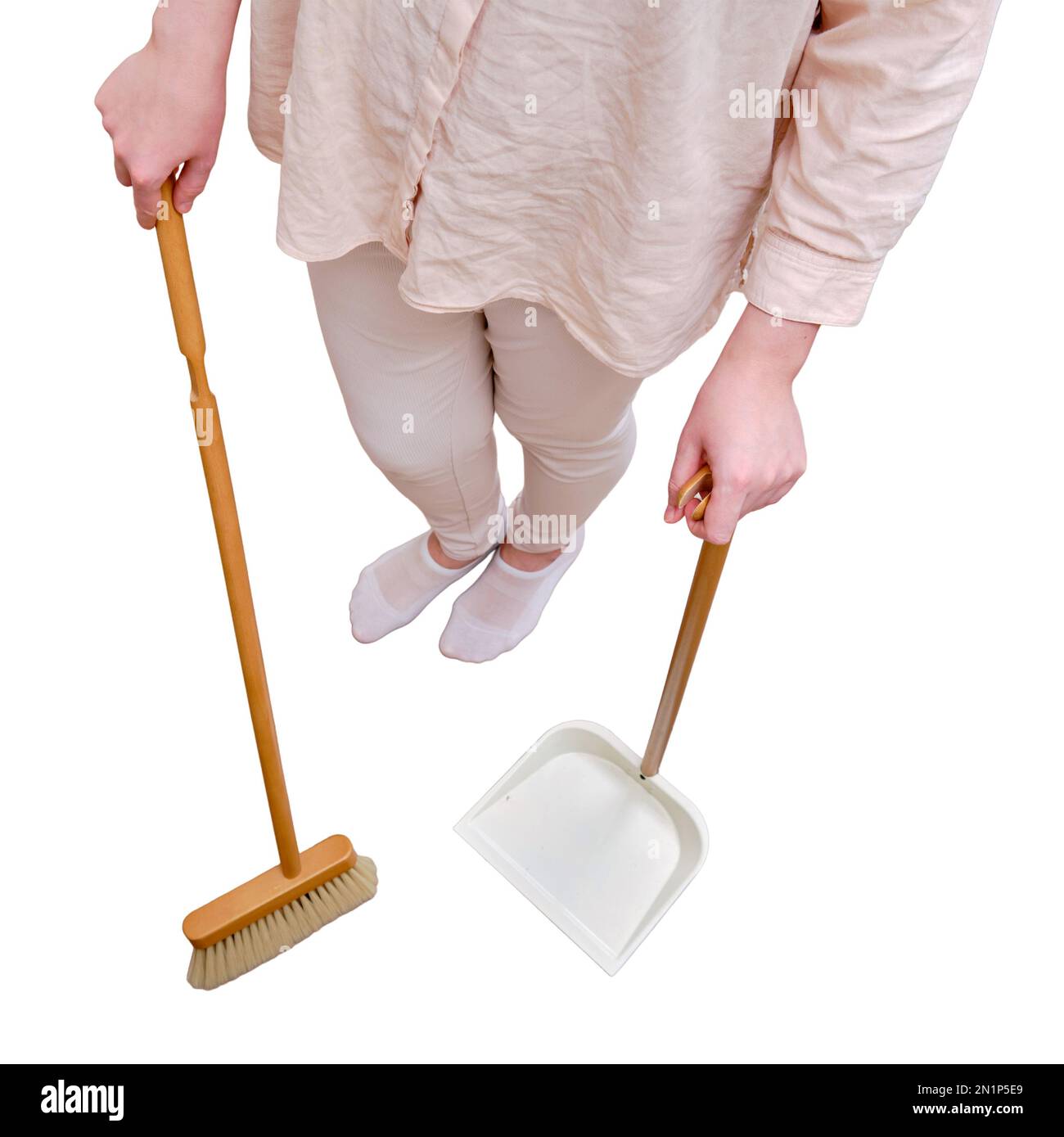 Woman sweeping floor with broom and dustpan while cleaning home living room, isolated on a white ...