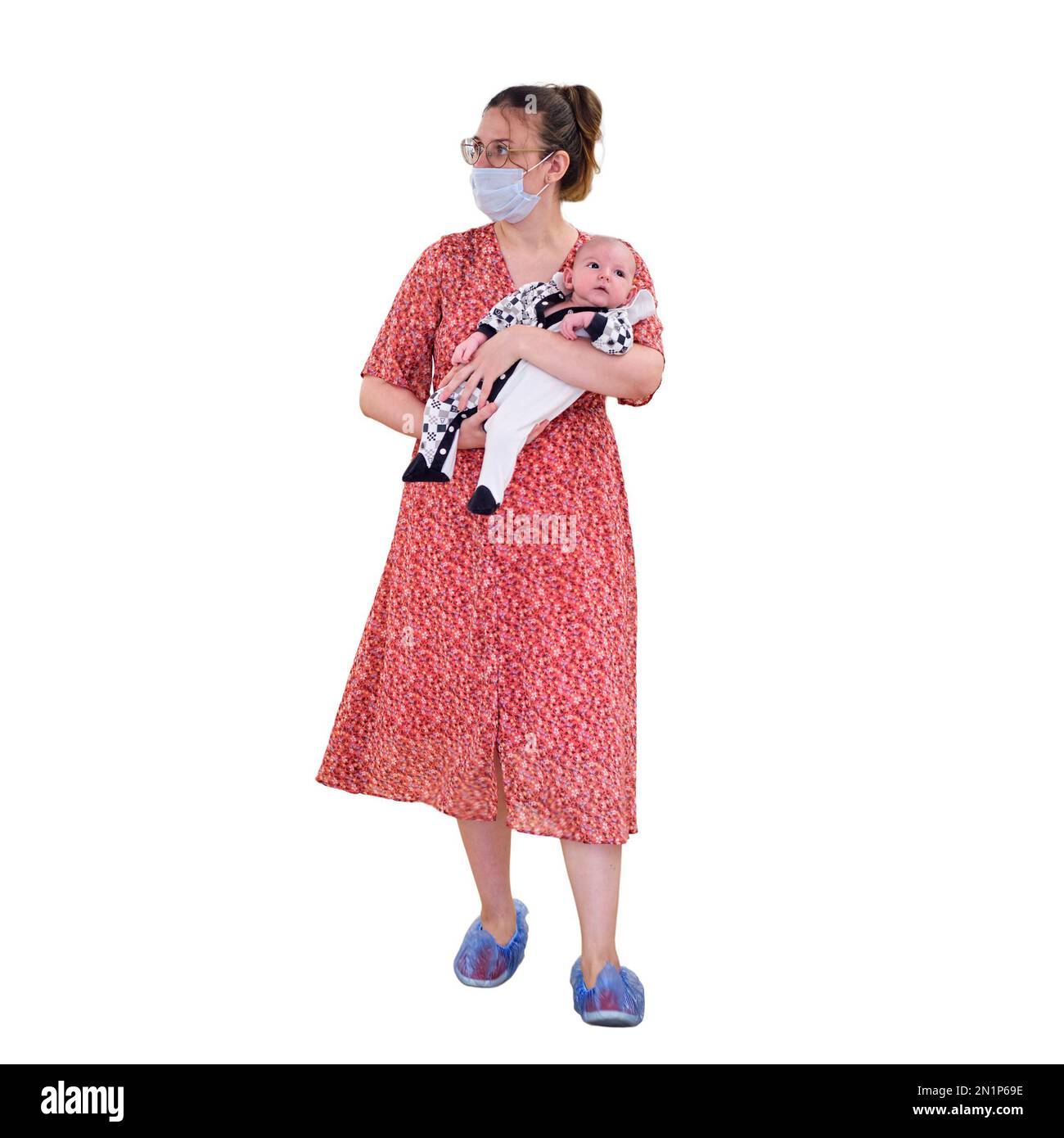 Woman mother in medical face mask holds baby boy, isolated on a white ...