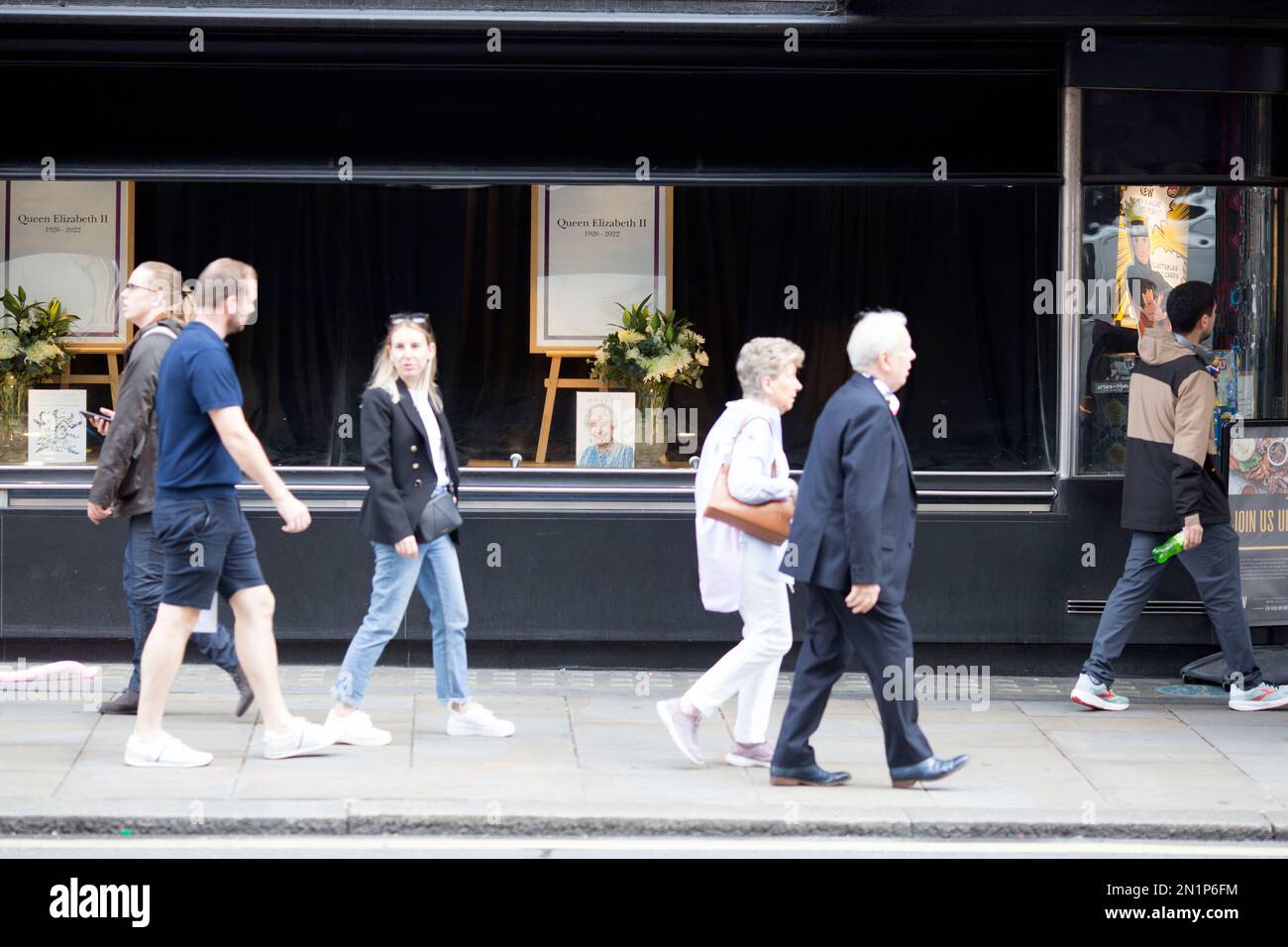A portrait of Queen Elizabeth II is displayed in a shop window in ...