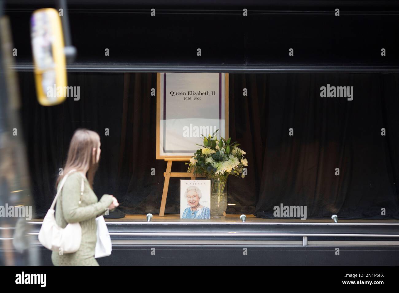 A portrait of Queen Elizabeth II is displayed in a shop window in ...