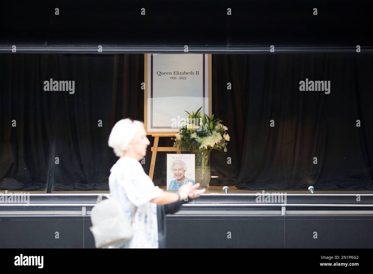 A portrait of Queen Elizabeth II is displayed in a shop window in ...