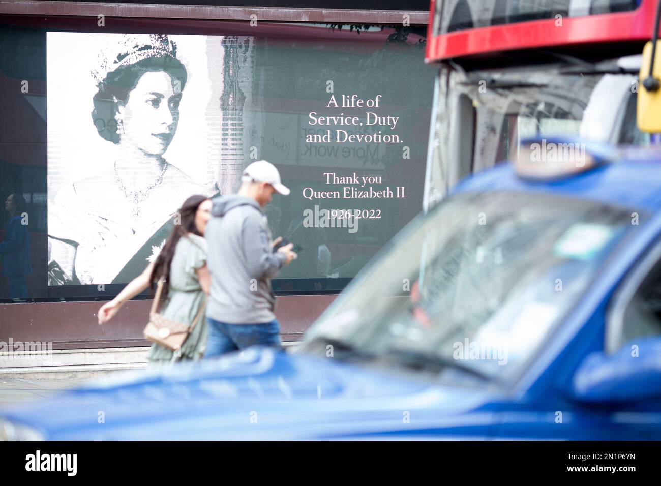 A portrait of Queen Elizabeth II is displayed in a shop window in ...