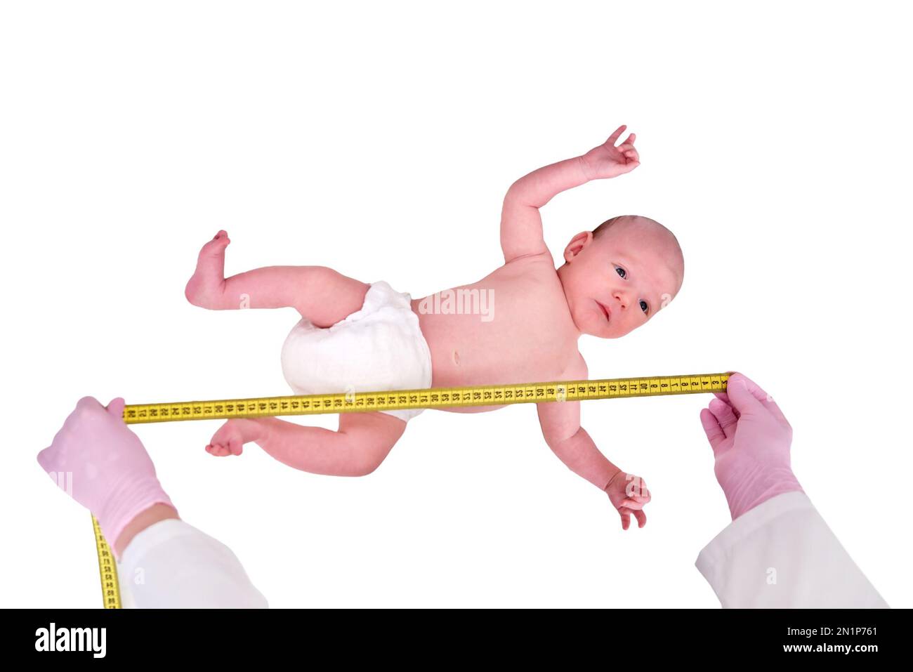Doctor measures the growth of a newborn baby, isolated on a white ...