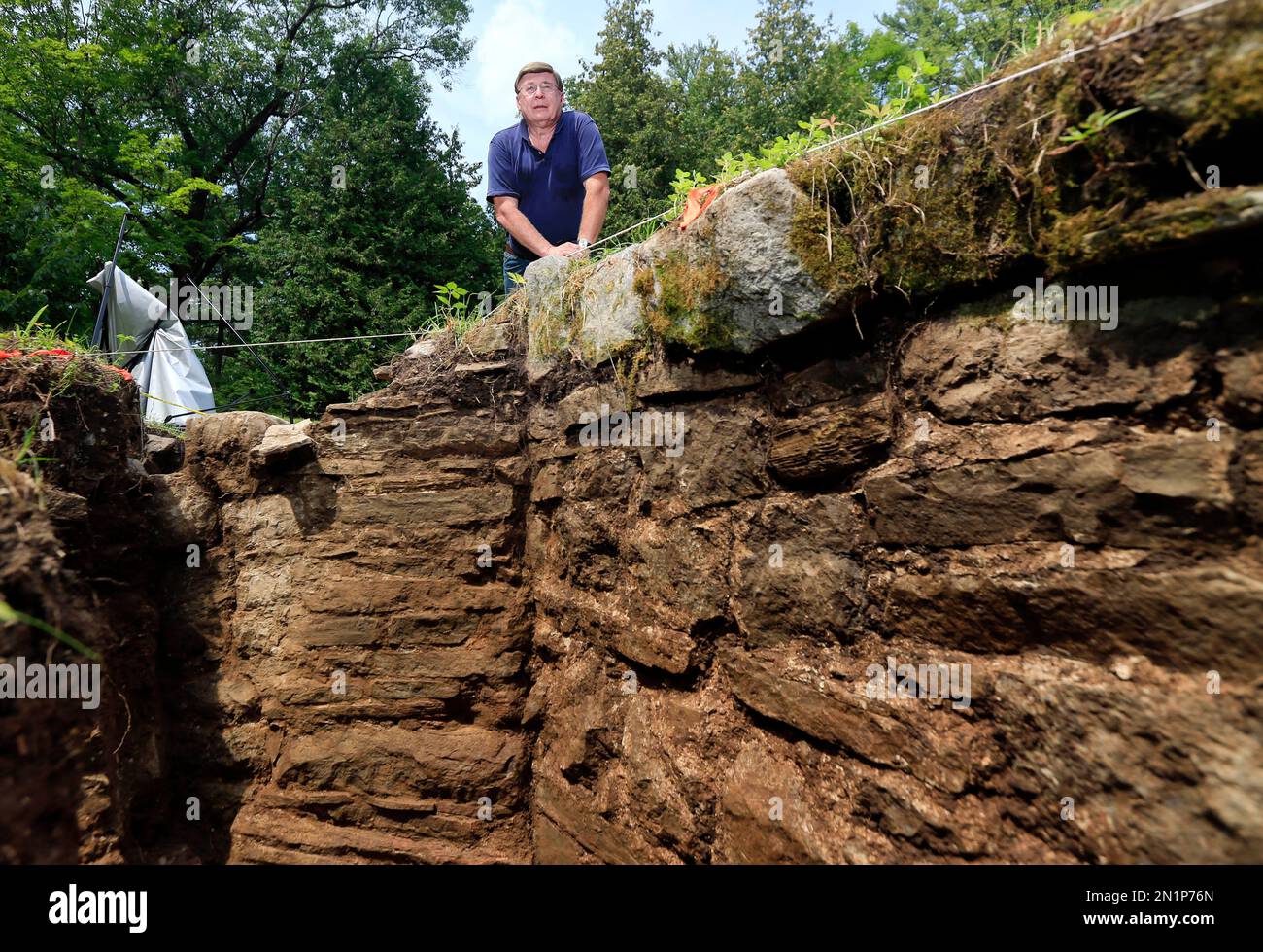 Archaeologist David Starbuck poses near a stone wall unearthed at Lake ...