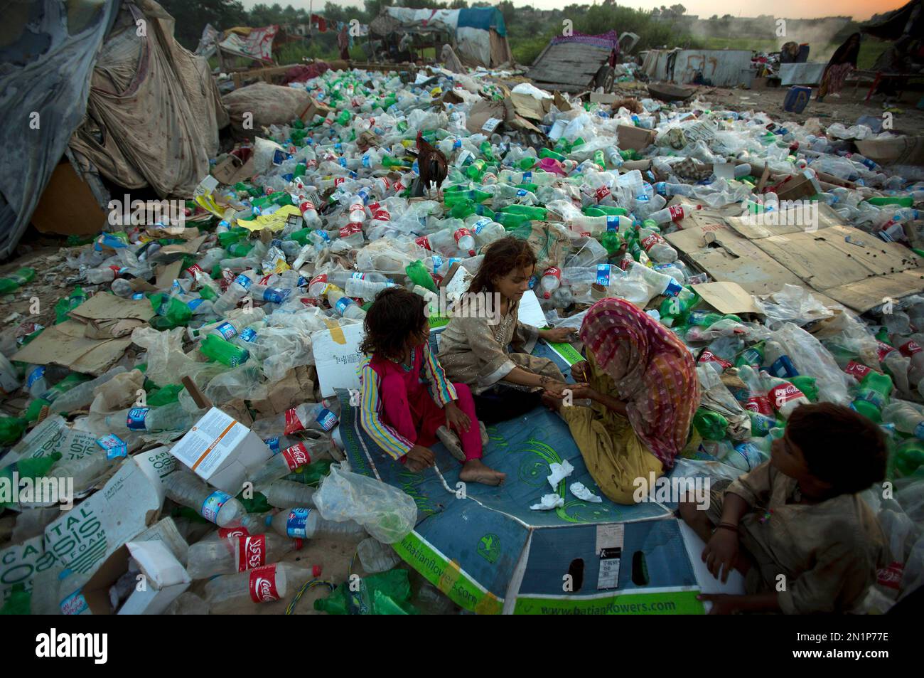 Pakistani girls paint their hands with henna outside their makeshift ...