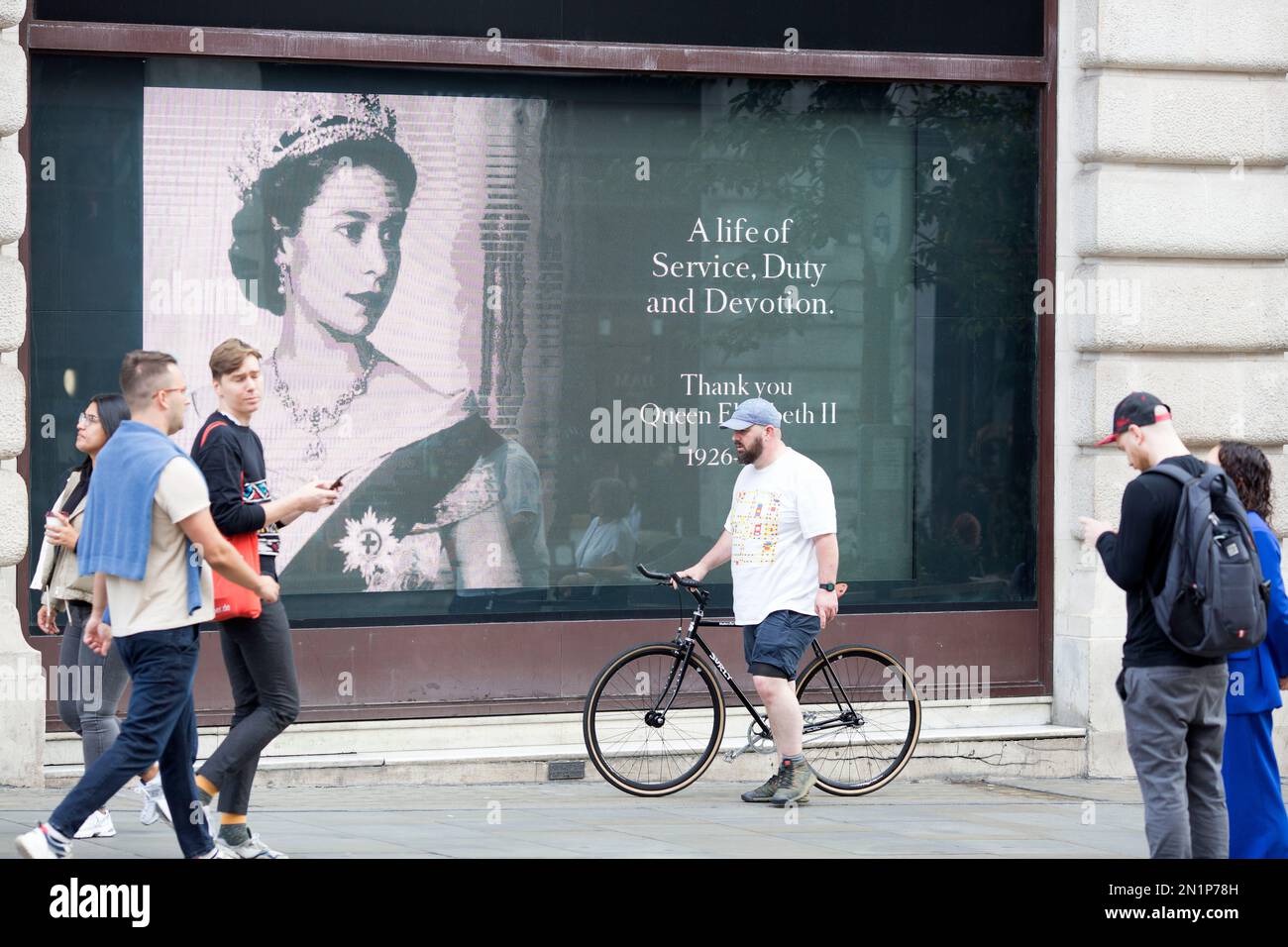 A portrait of Queen Elizabeth II is displayed in a shop window in ...