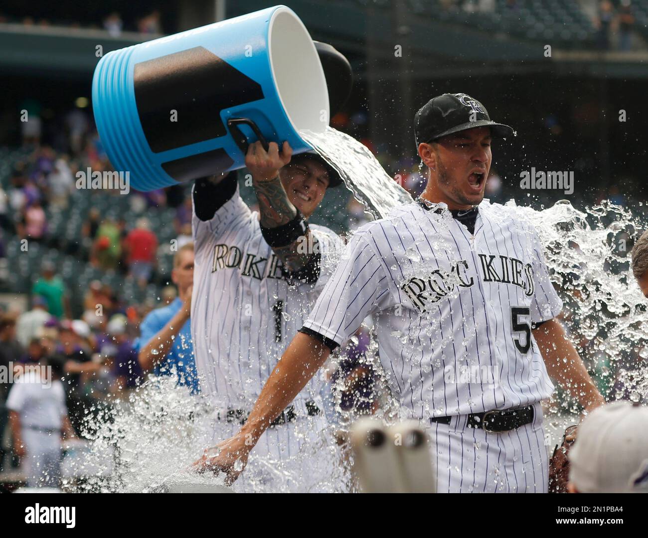 Colorado Rockies starting pitcher Chris Rusin is doused by left fielder ...