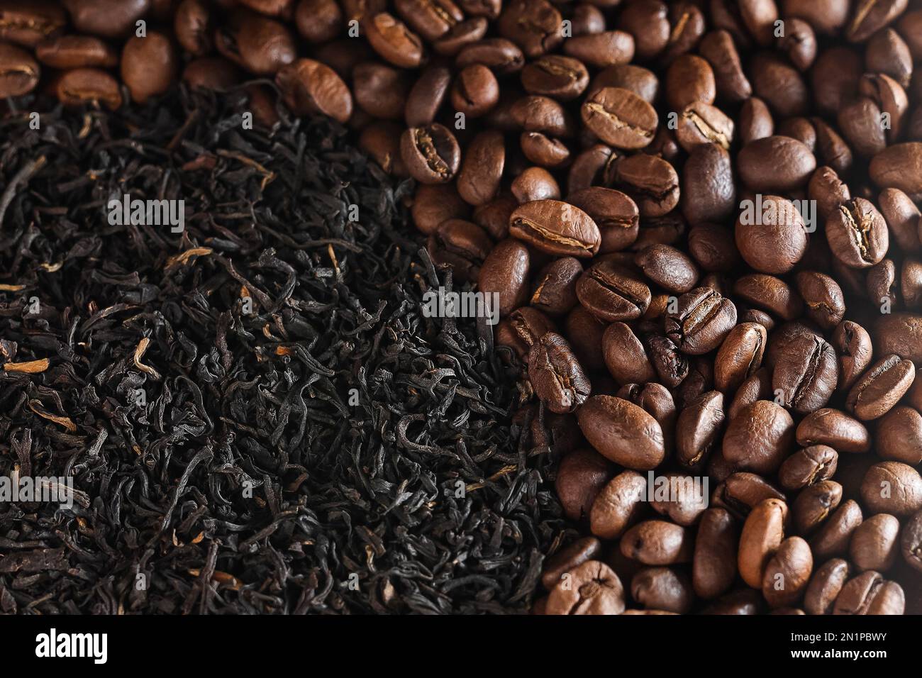 tea or coffee? coffee beans and natural black tea top view. coffee vs ...