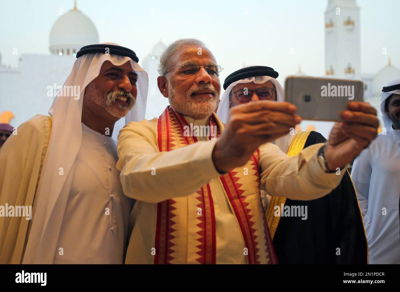 Indian Prime Minister Narendra Modi, middle, takes a selfie next to ...