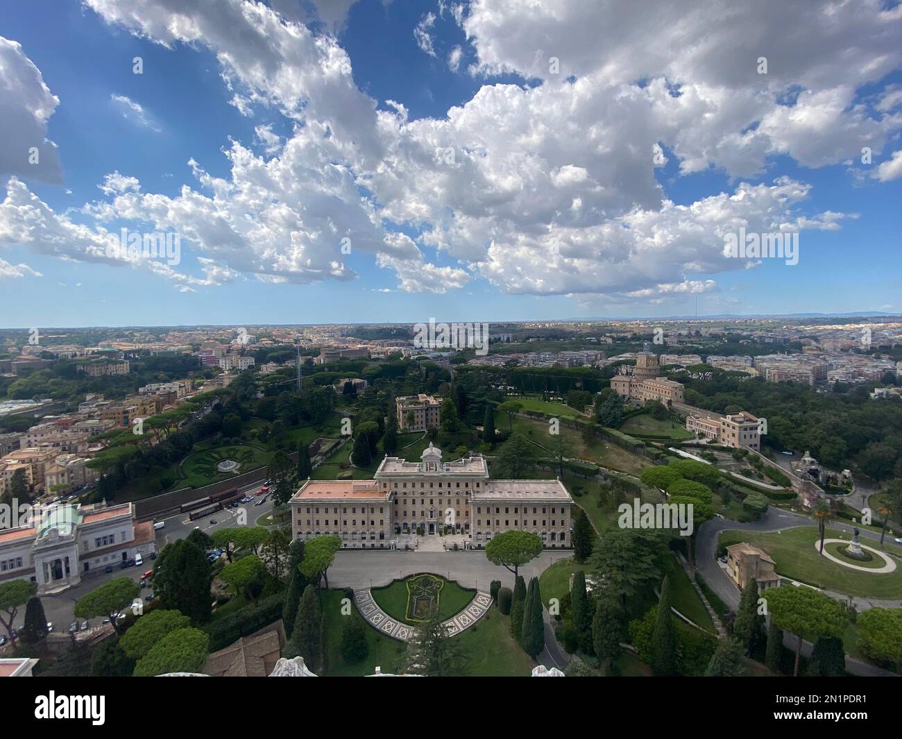An aerial view of modern buildings surrounded by trees in Vatican City ...