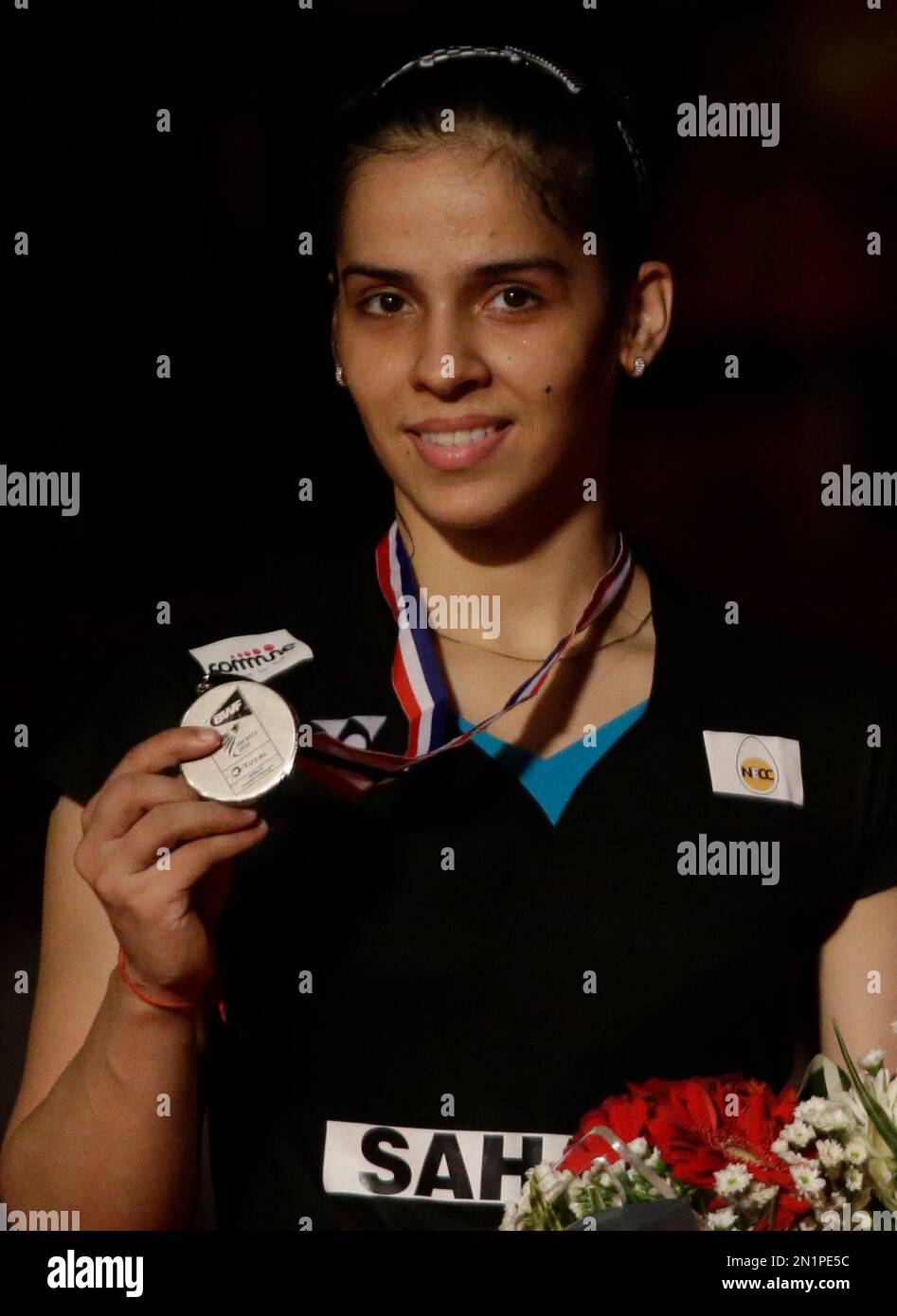 India's Saina Nehwal poses for a photo with her silver medal during an ...