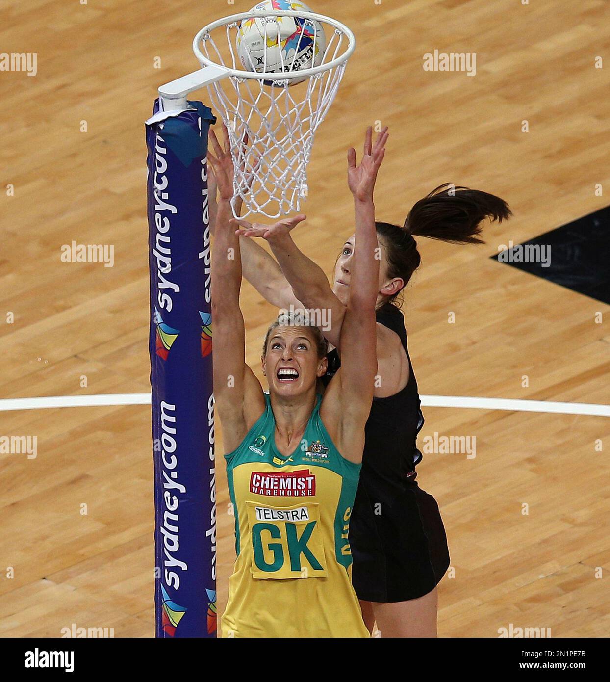 Australia's Laura Geitz, front, and New Zealand's Bailey Mes jump to ...