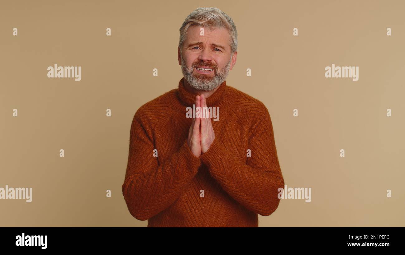Please, God help, forgive me. Middle-aged old man praying, looking ...