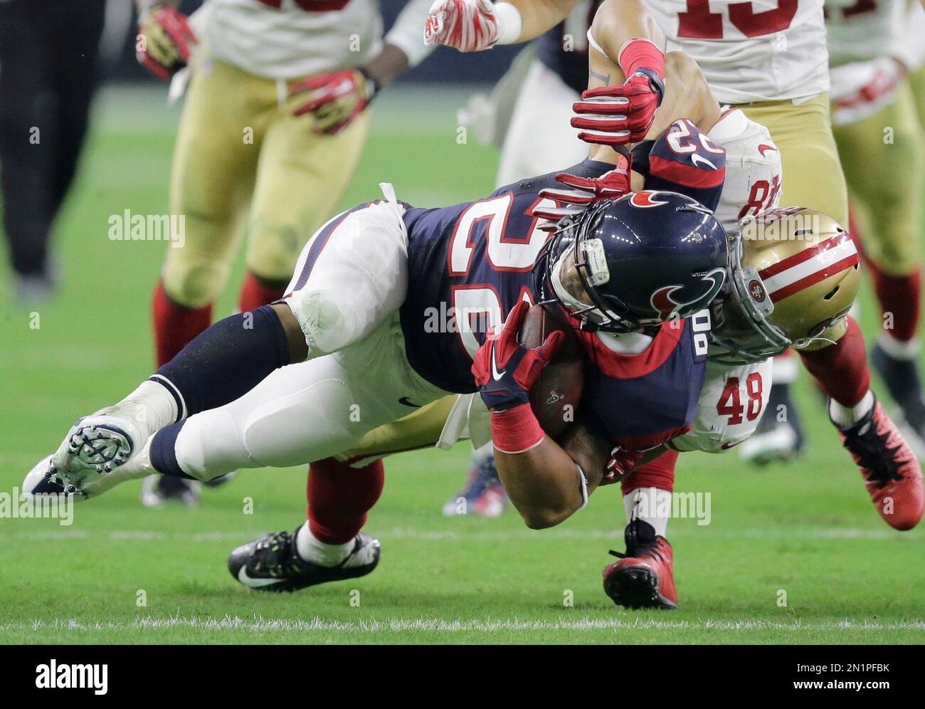 Houston Texans' Chris Polk (22) is dropped by San Francisco 49ers' Rory ...