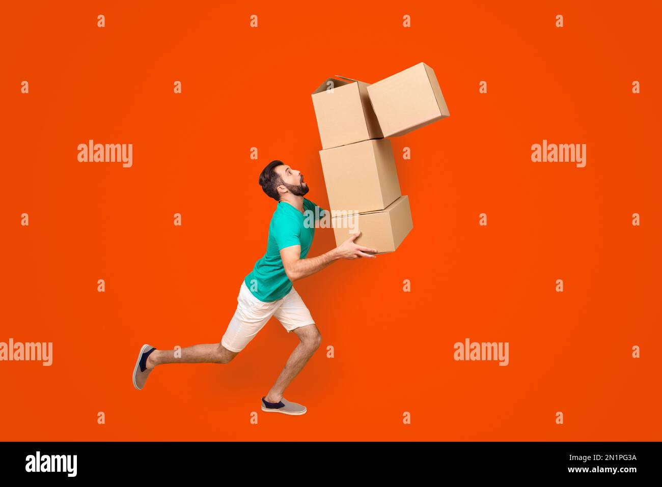 Funny nervous man is carrying his stuff in boxes to the recently bought ...