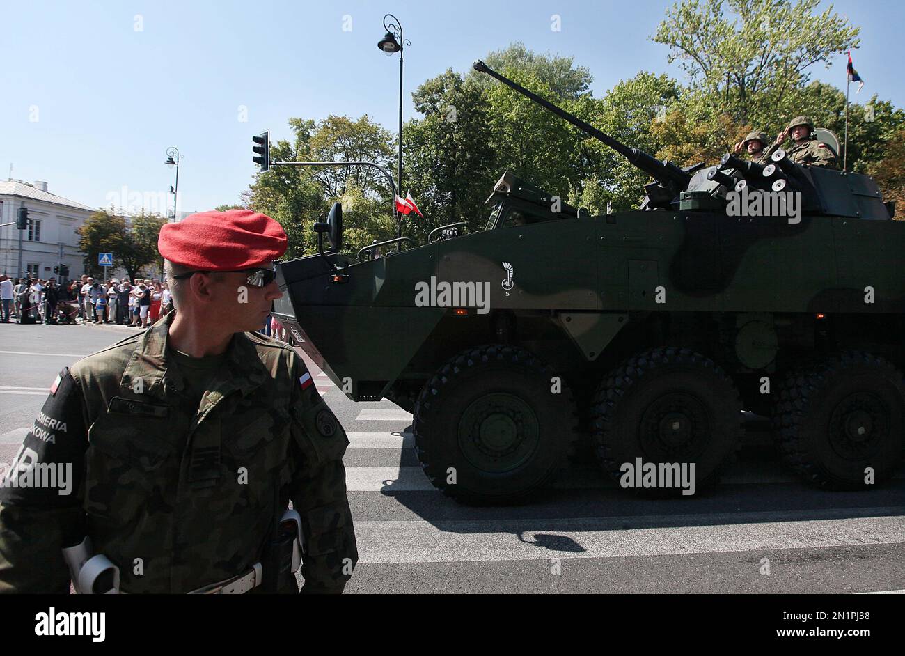 Polish army soldiers salute as tanks roll on one of the city's main ...