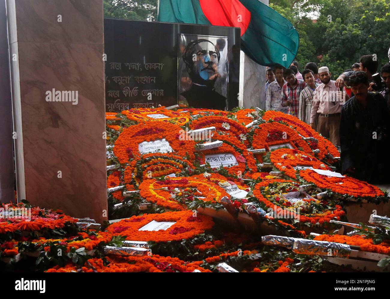 Bangladeshi people offer floral tribute to a portrait of Sheikh Mujibur ...