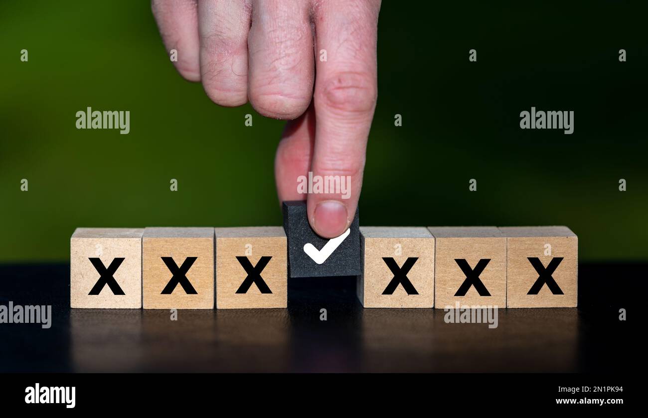 Hand selects a black cube. Symbol for making an decision Stock Photo ...