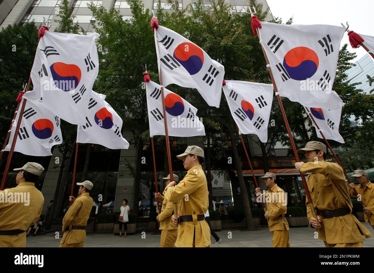 South Koreand wearing liberation army uniforms carry their national ...