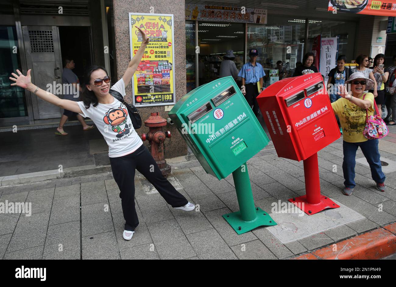 In this Friday, Aug. 14, 2015 photo, two women pose for photographs ...