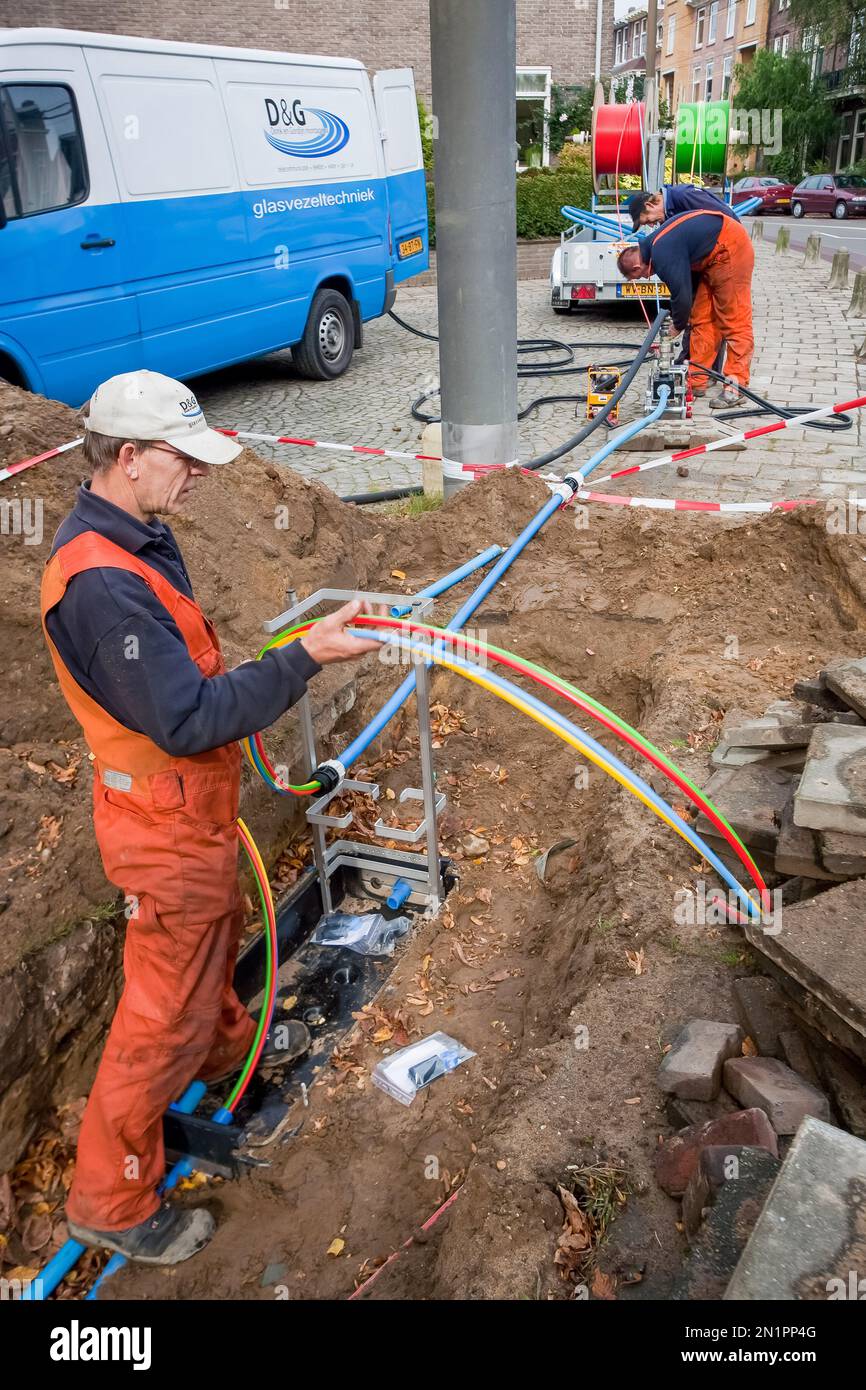 10067847, Netherlands, Arnhem. Installing fiberglass cables in a street ...