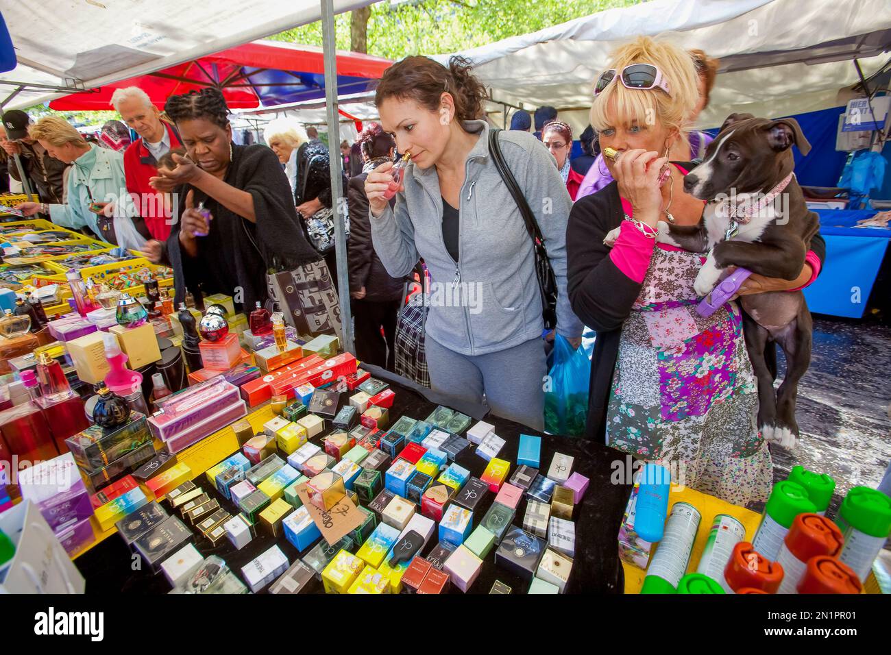 Netherlands, women are smelling perfume bottles at a market stall Stock ...