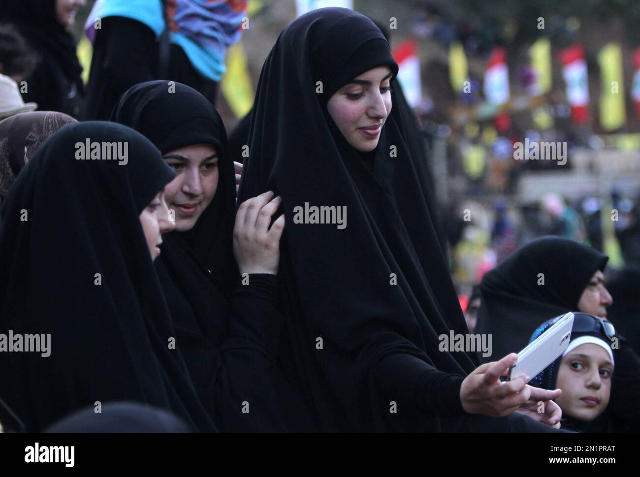 Female Hezbollah supporters take selfie with a mobile phone, as they ...
