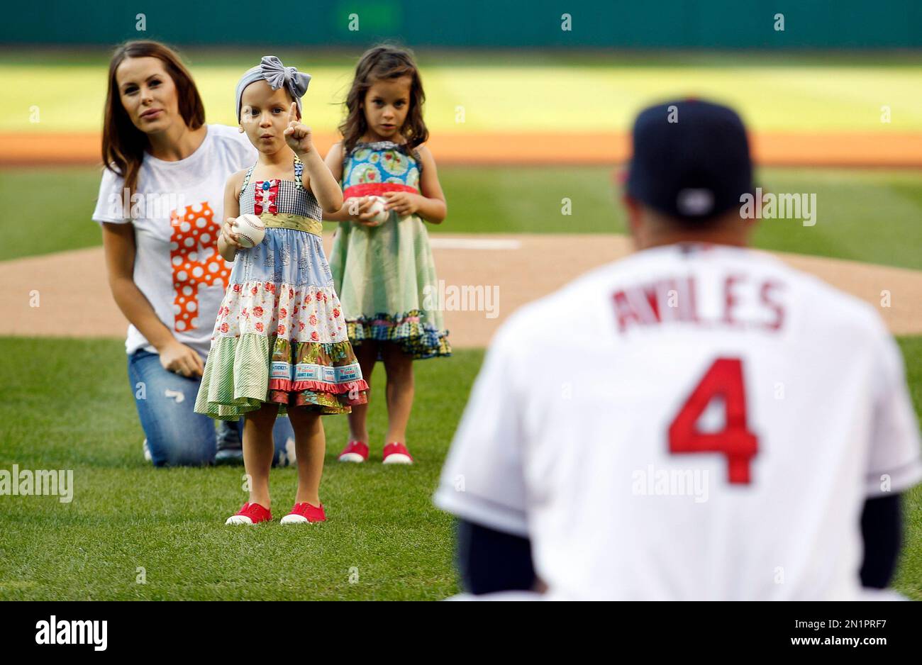 Cleveland Indians Mike Aviles waits to catch the ceremonial first pitch ...