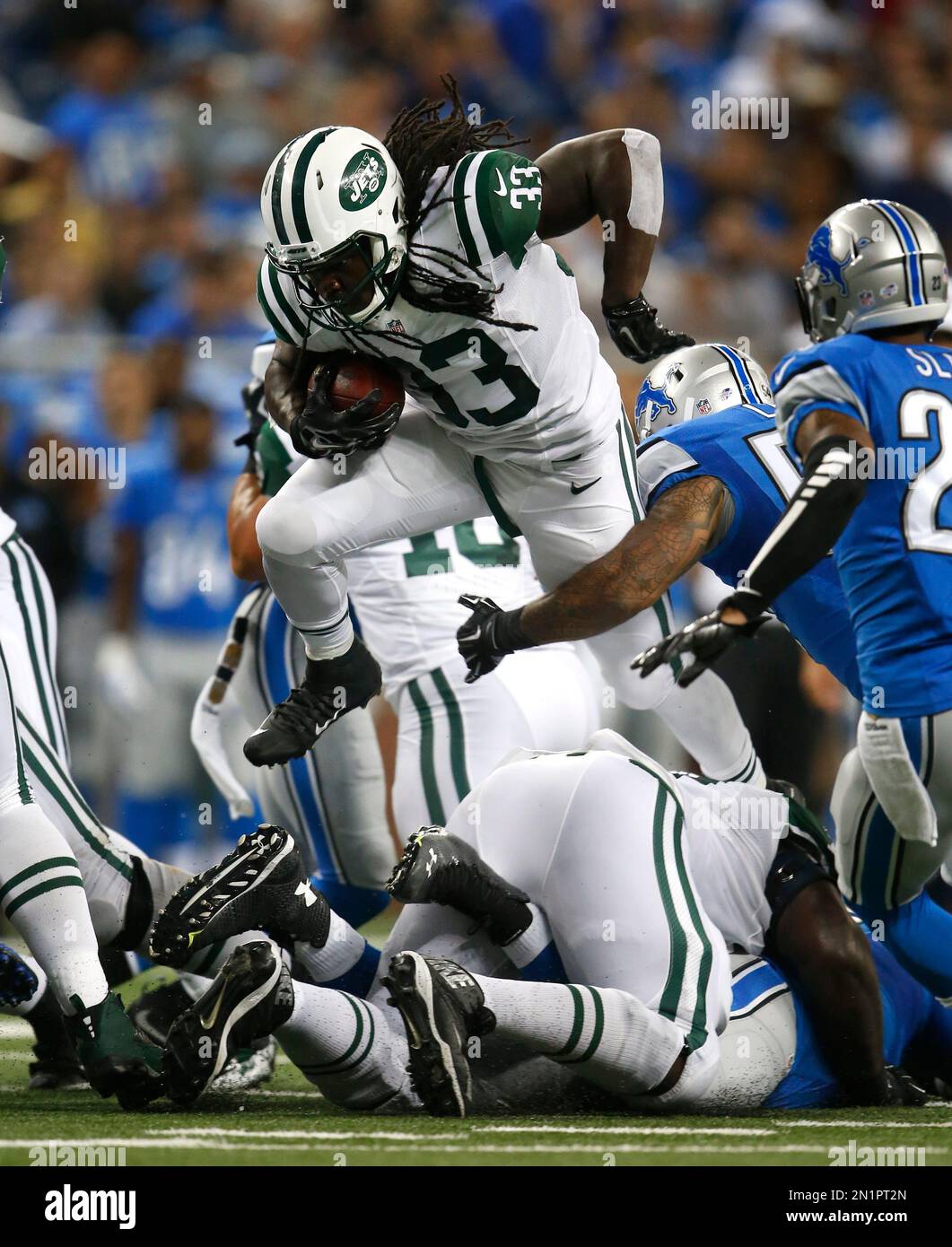 New York Jets running back Chris Ivory jumps over the Detroit Lions ...