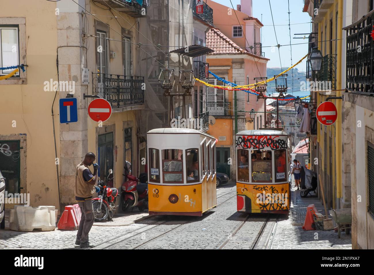 Portugal, Cable car in the old centre of Lisbon with a view of the sea ...