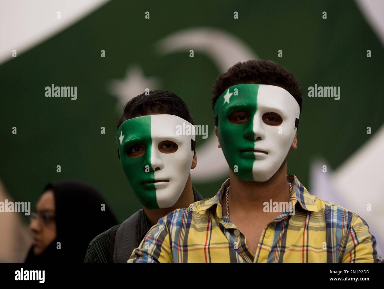 Pakistani youngsters wear masks painted in the design of the national ...